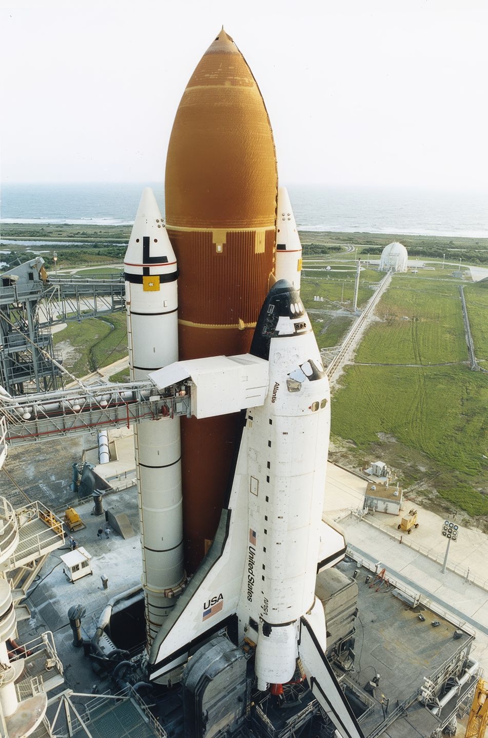 Assembly | Space shuttle ATLANTIS is positioned above the mobile launch ...