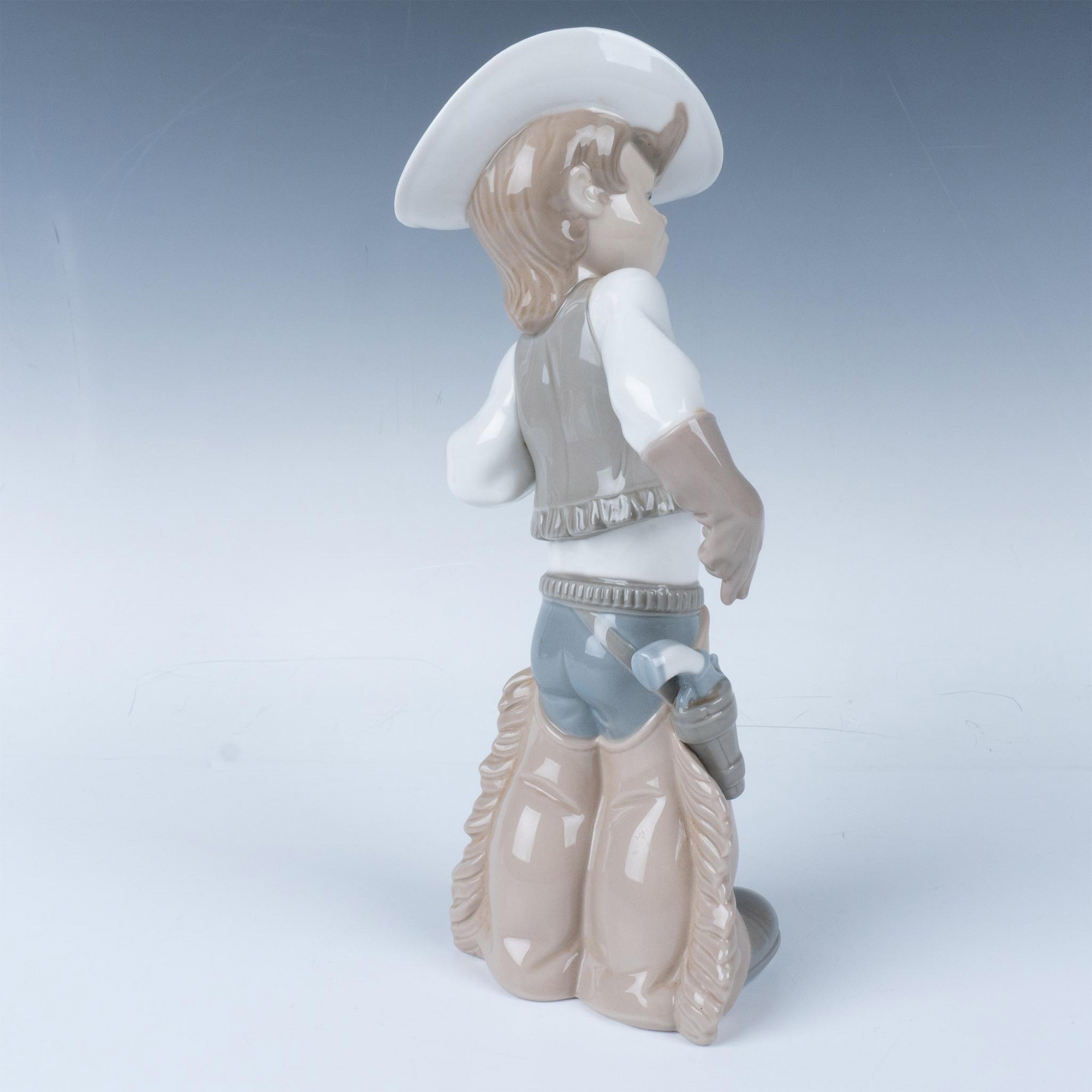 Juan Huerta | Glazed figure of a cheerful and bold cowboy smiling while ...