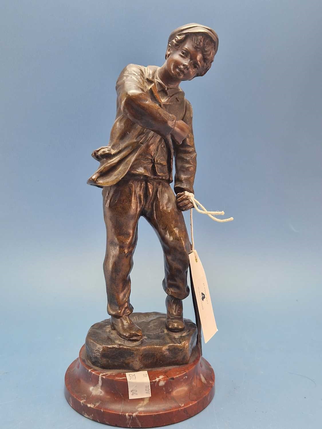 Oscar Ruffoni | a bronze figure of a man standing above a red marble ...