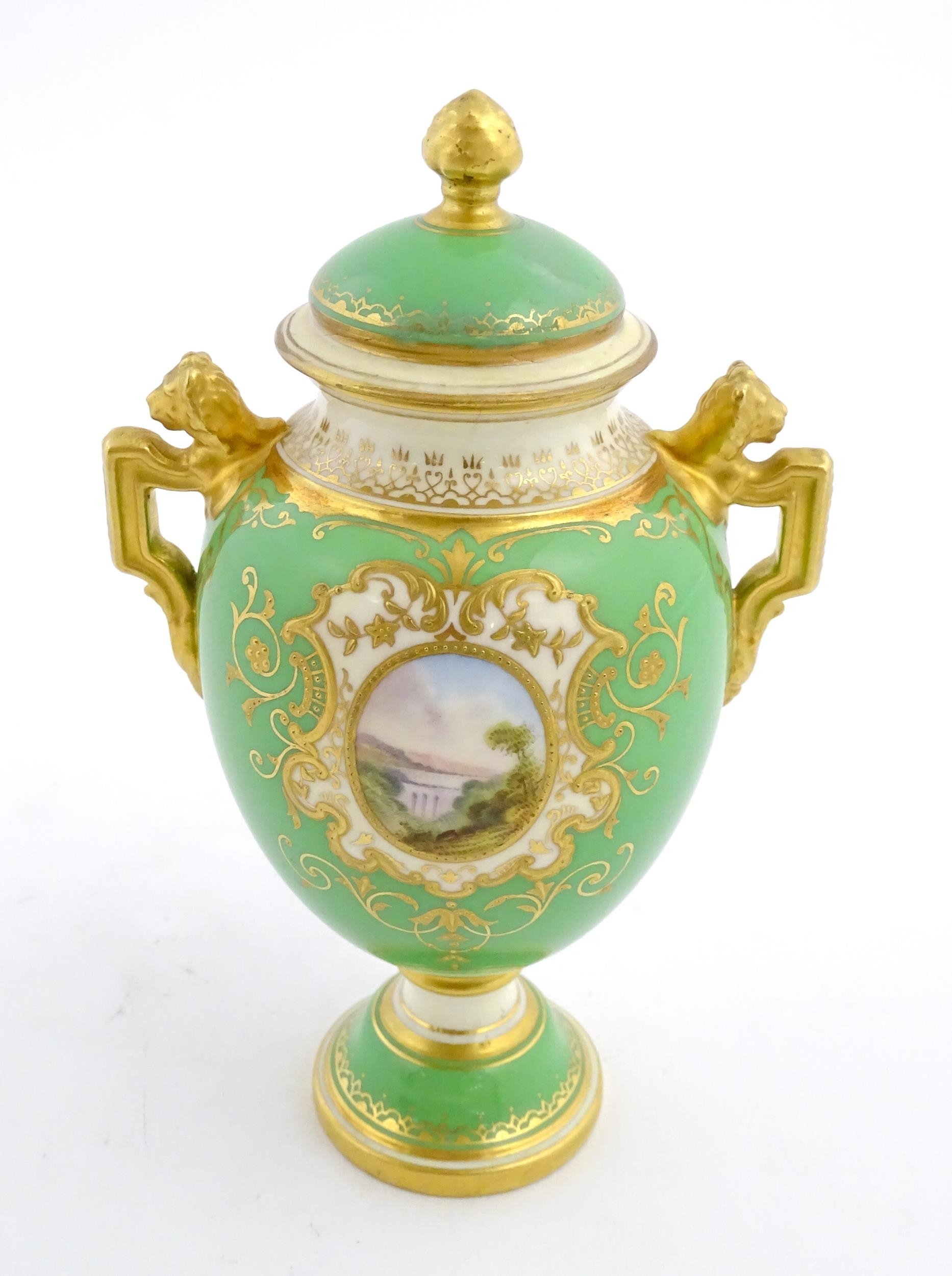 Coalport | A Coalport urn and cover with twin lion head handles, the ...