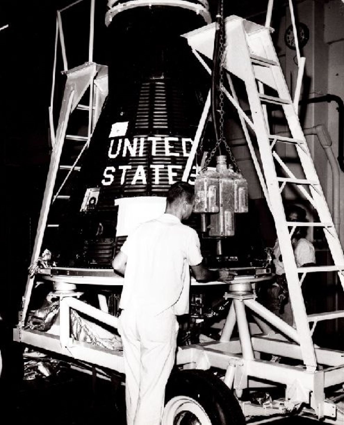 NASA | Preparation of a Mercury capsule to be placed on the fuselage of ...