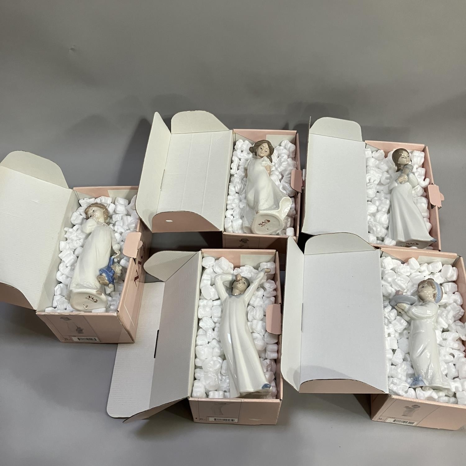 BREAKFAST | Five Nao figures of children in nightwear, one with ...