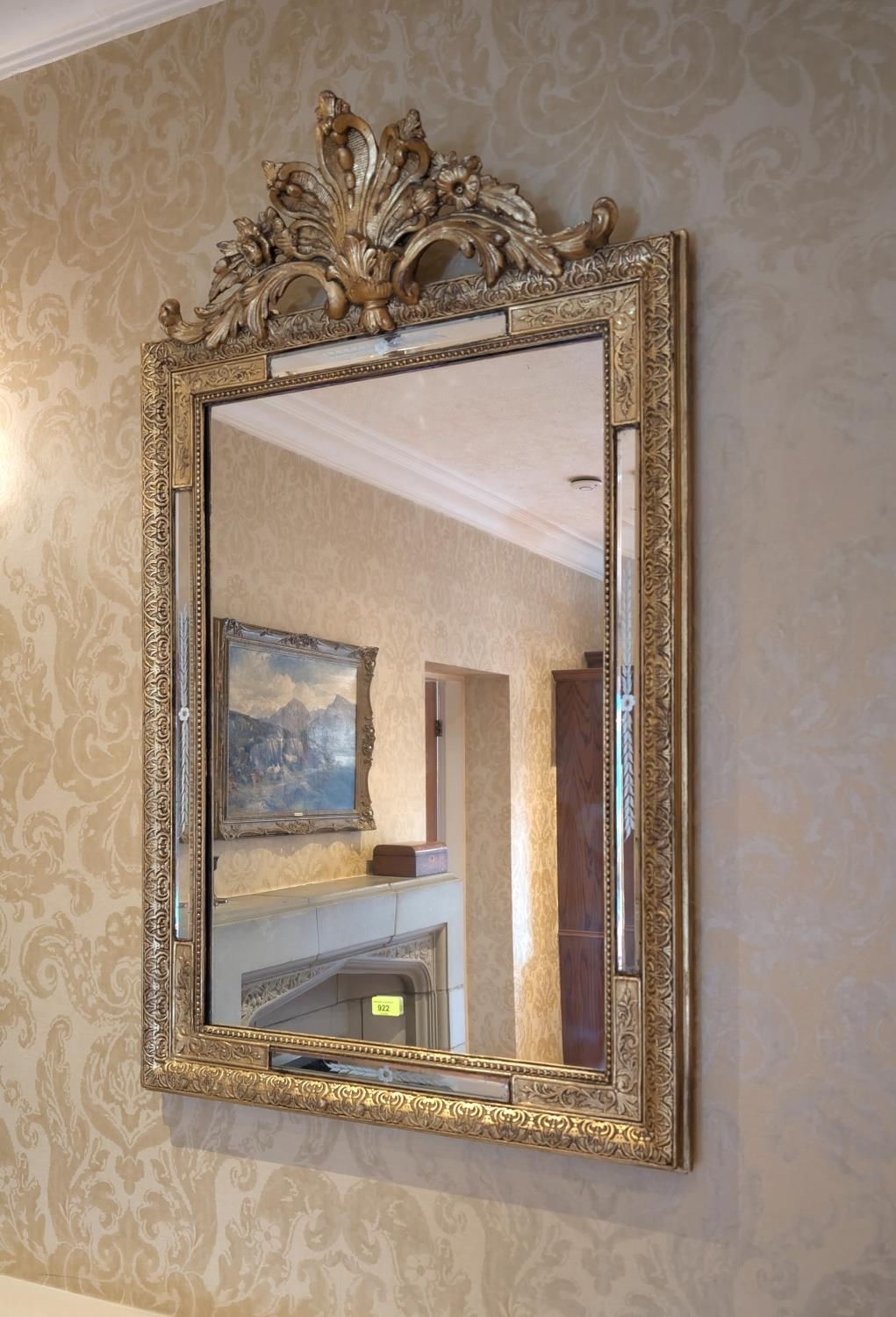Above | A Venetian style gilt framed wall mirror with floral finial ...