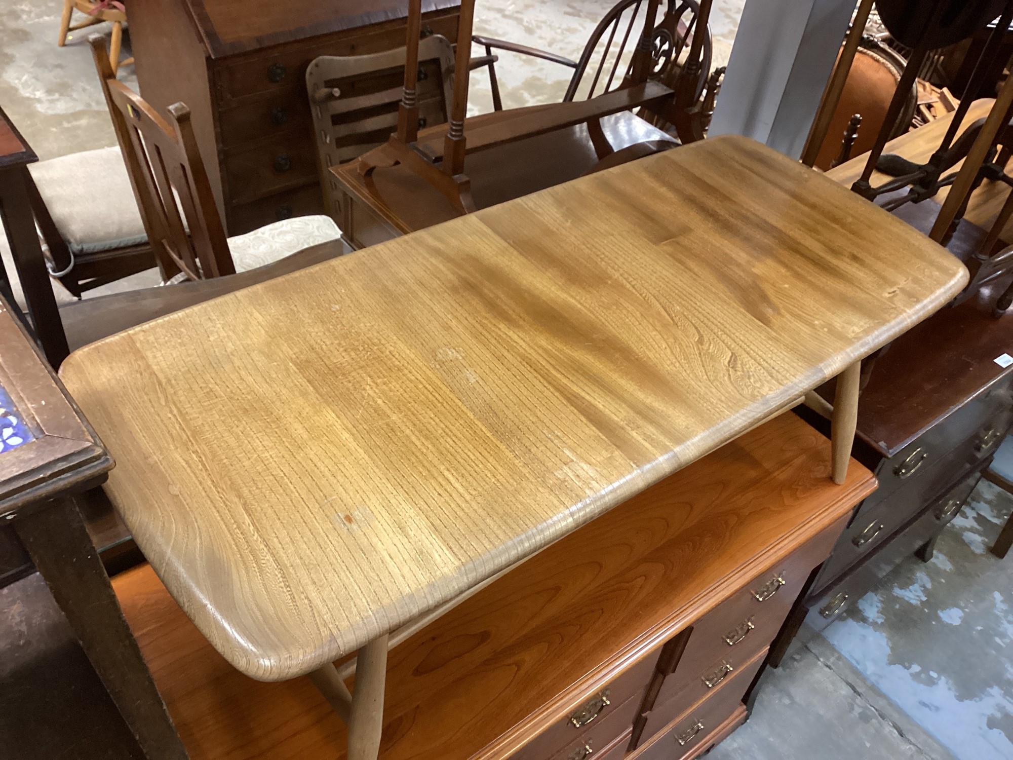 Coffee | Ercol coffee table with magazine rack undertier, 105cm x 46cm x 36.5cm high | MutualArt