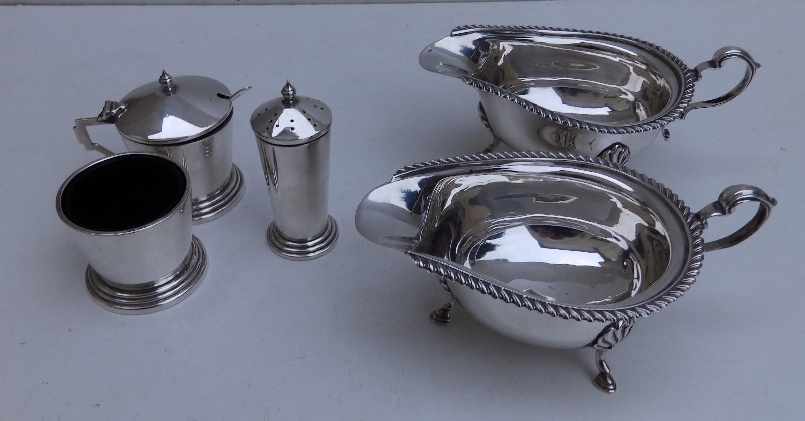 Three | A pair of Birmingham silver sauceboats and a three piece sil ...