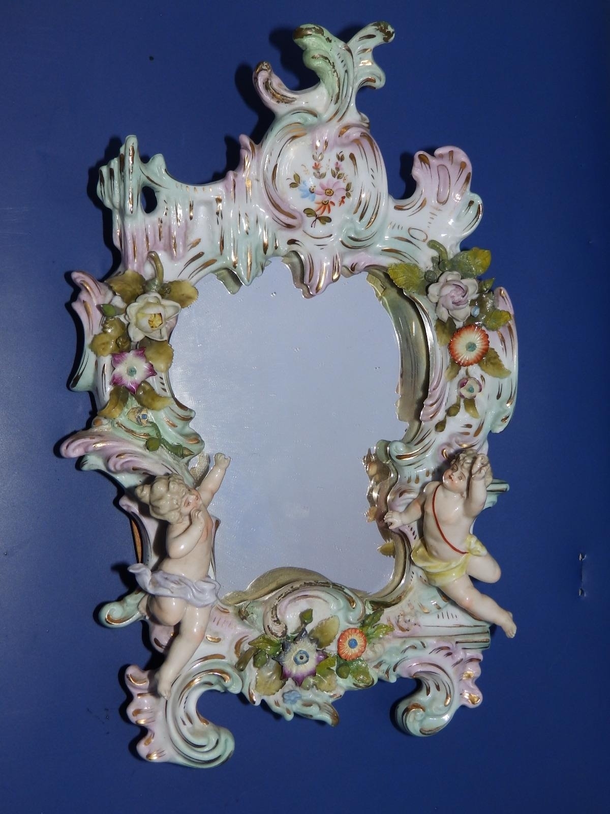 Meissen | A small Meissen rococo style wall mirror modelled with figur ...