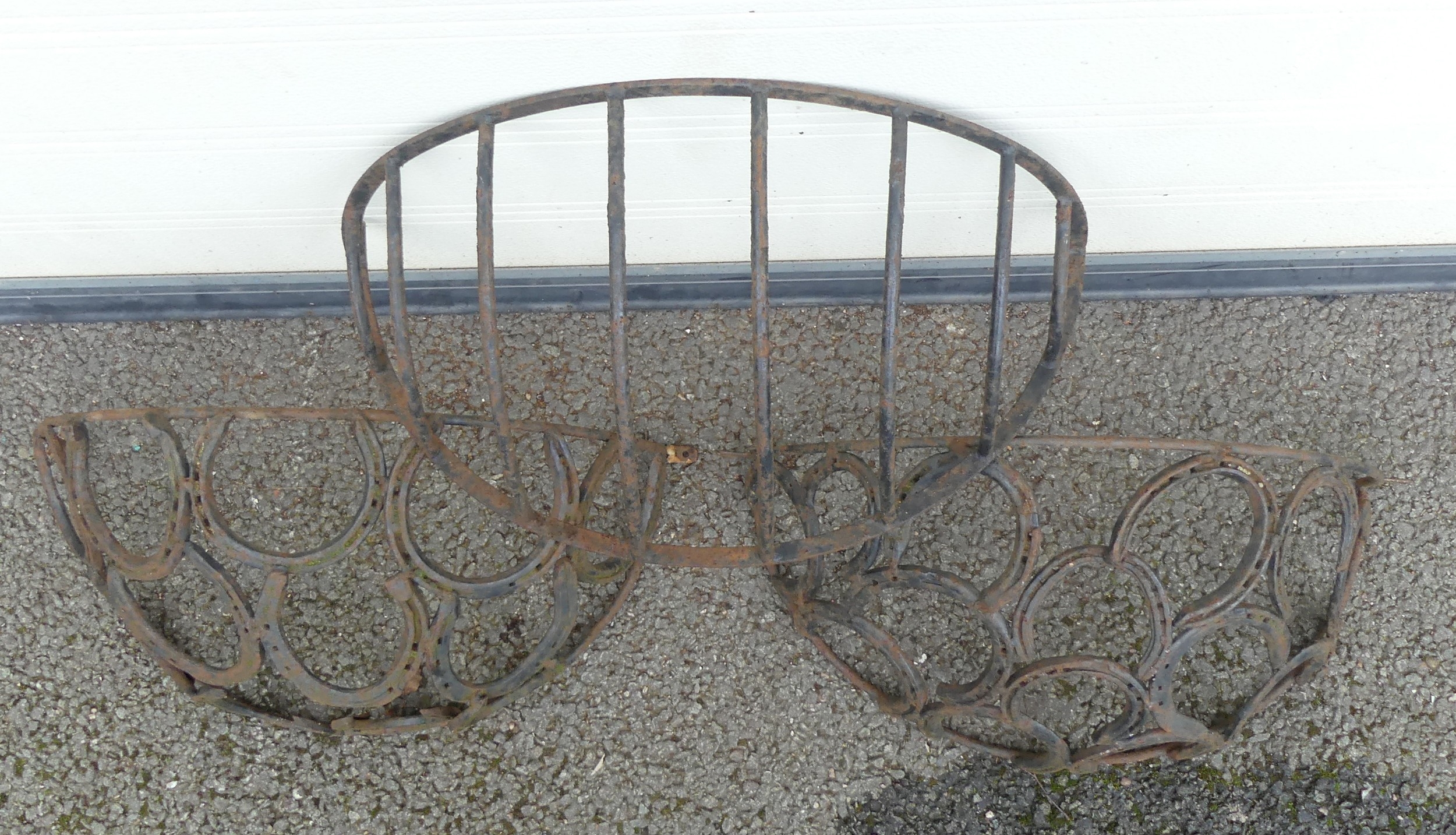 Three | Three metal garden wall planters/hay racks, two made out of ...