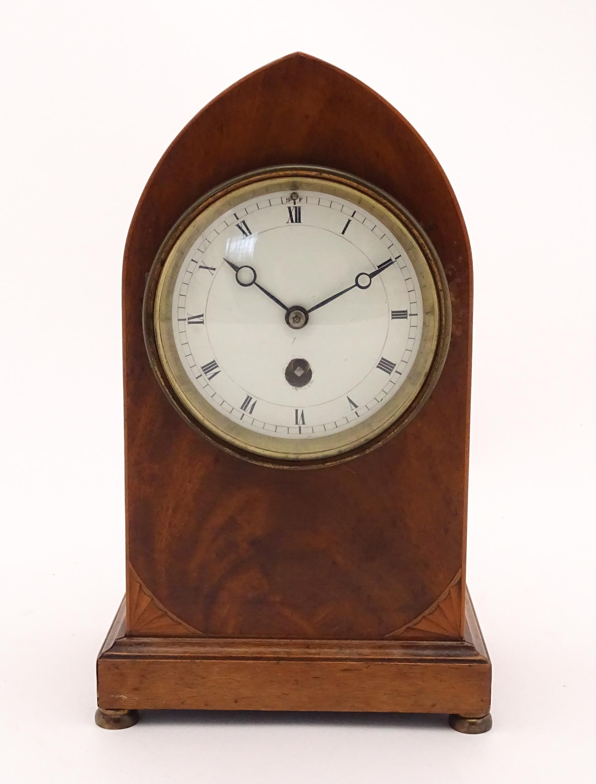Paris | A mahogany cased lancet shaped mantle clock with white ename ...