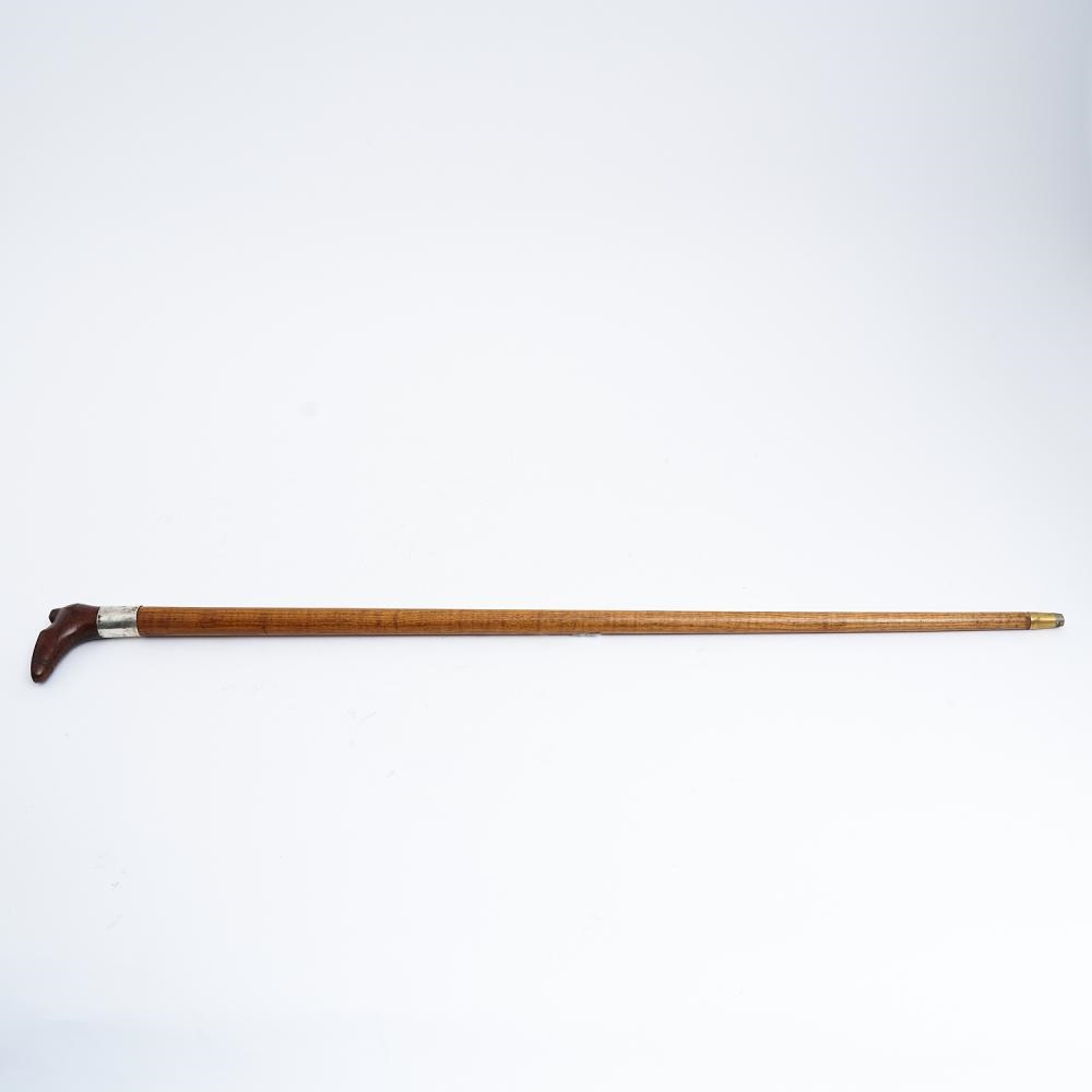 Stick | A BLACKWOOD SHAFTED AND CARVED CEDAR BOOT FORM HANDLED AND ...