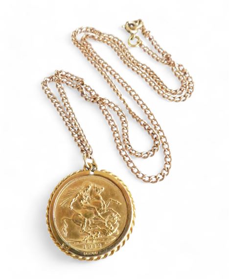 George | A gold full sovereign pendant and curblink chain necklace ...