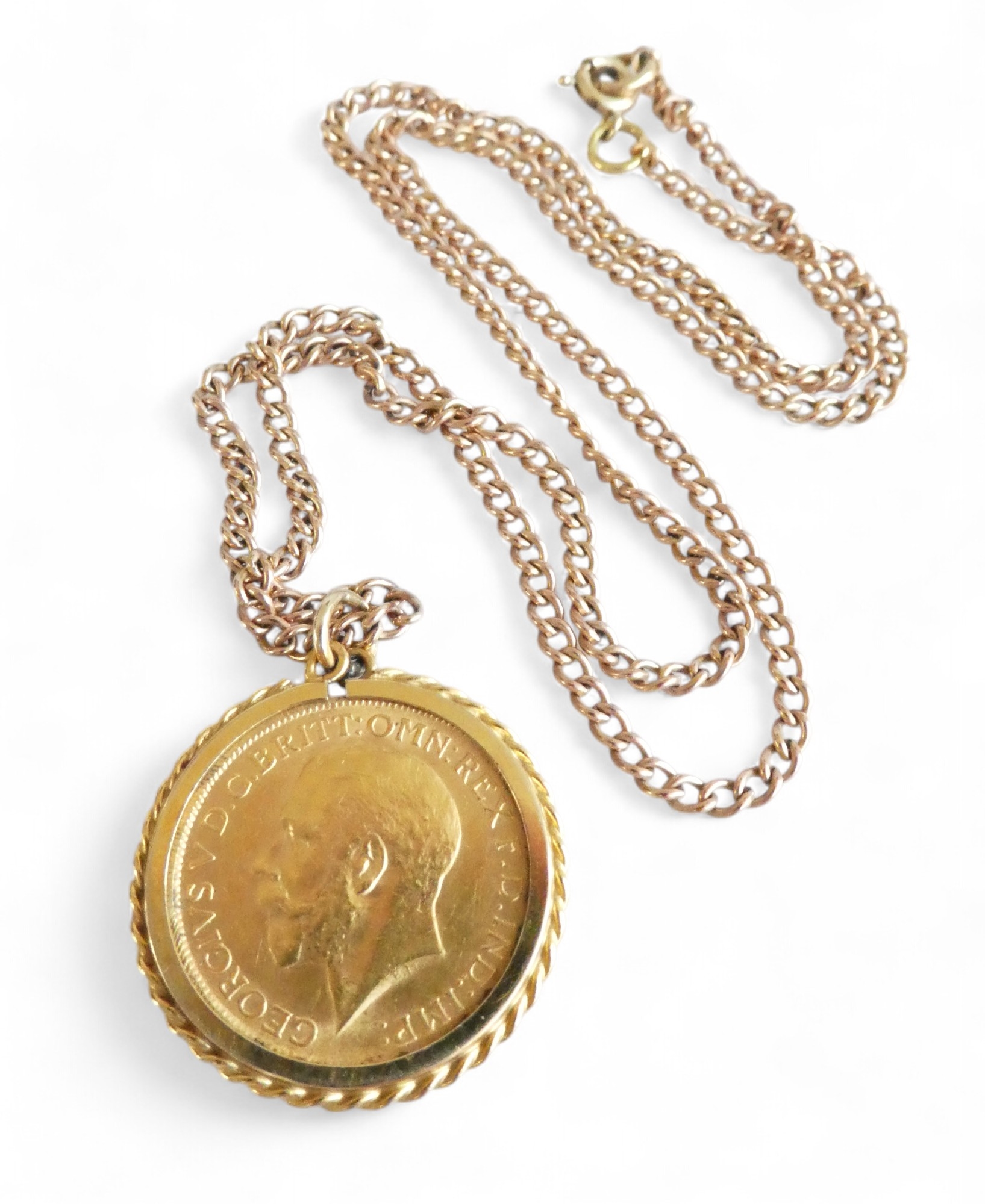 George | A gold full sovereign pendant and curblink chain necklace ...