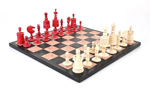 Black | Early 20th Century hand-carved bone chess set with a polished ...