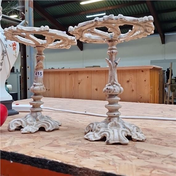 White | Pair of ornate cast iron trivet stands featuring an elegant ...