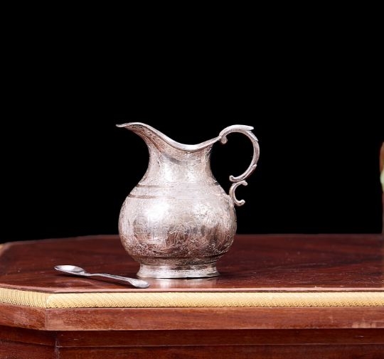 Silver | AN INDIAN SILVER MILK JUG AND SPOON | MutualArt