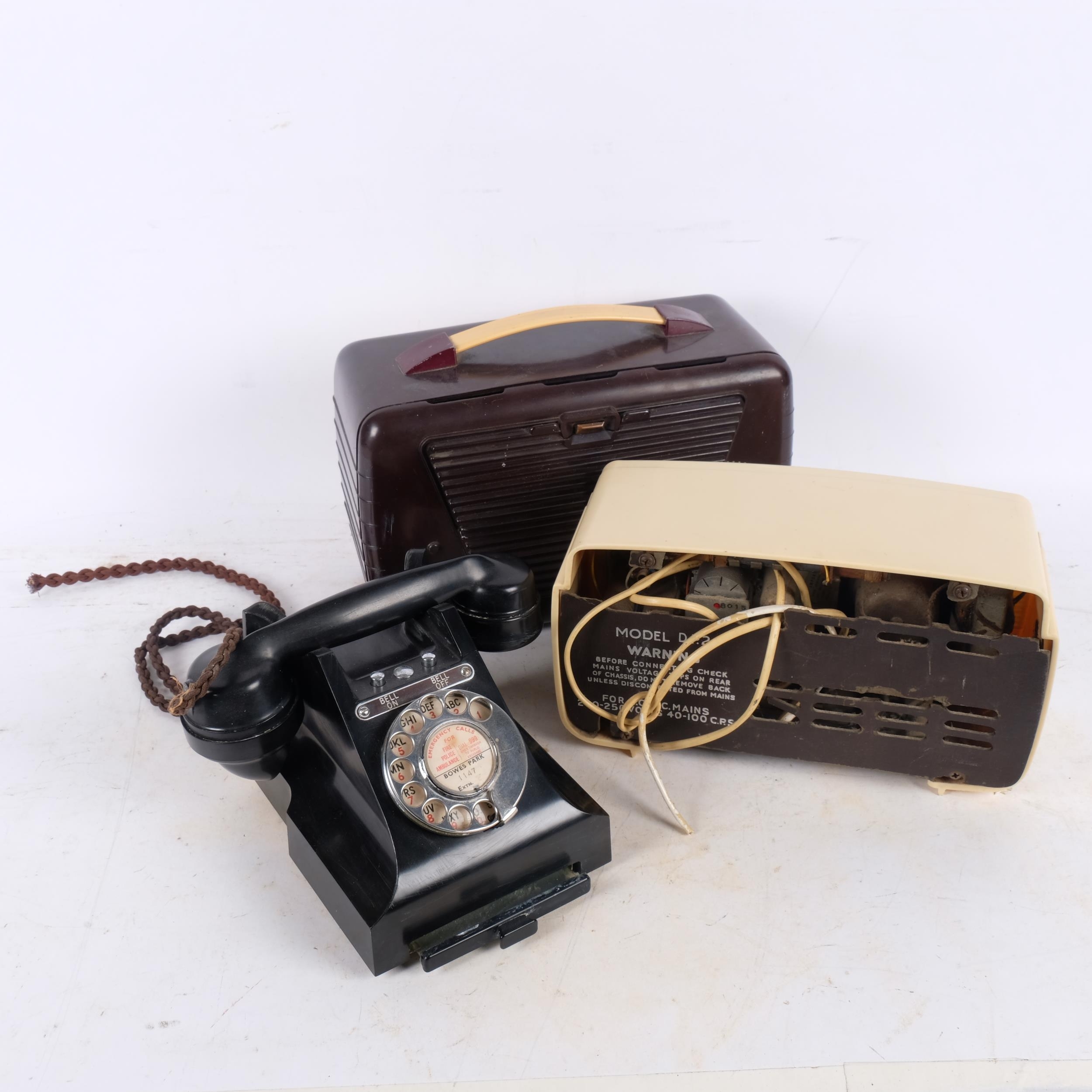 Black | A black Bakelite dial telephone with drawer under, a Bakelite ...
