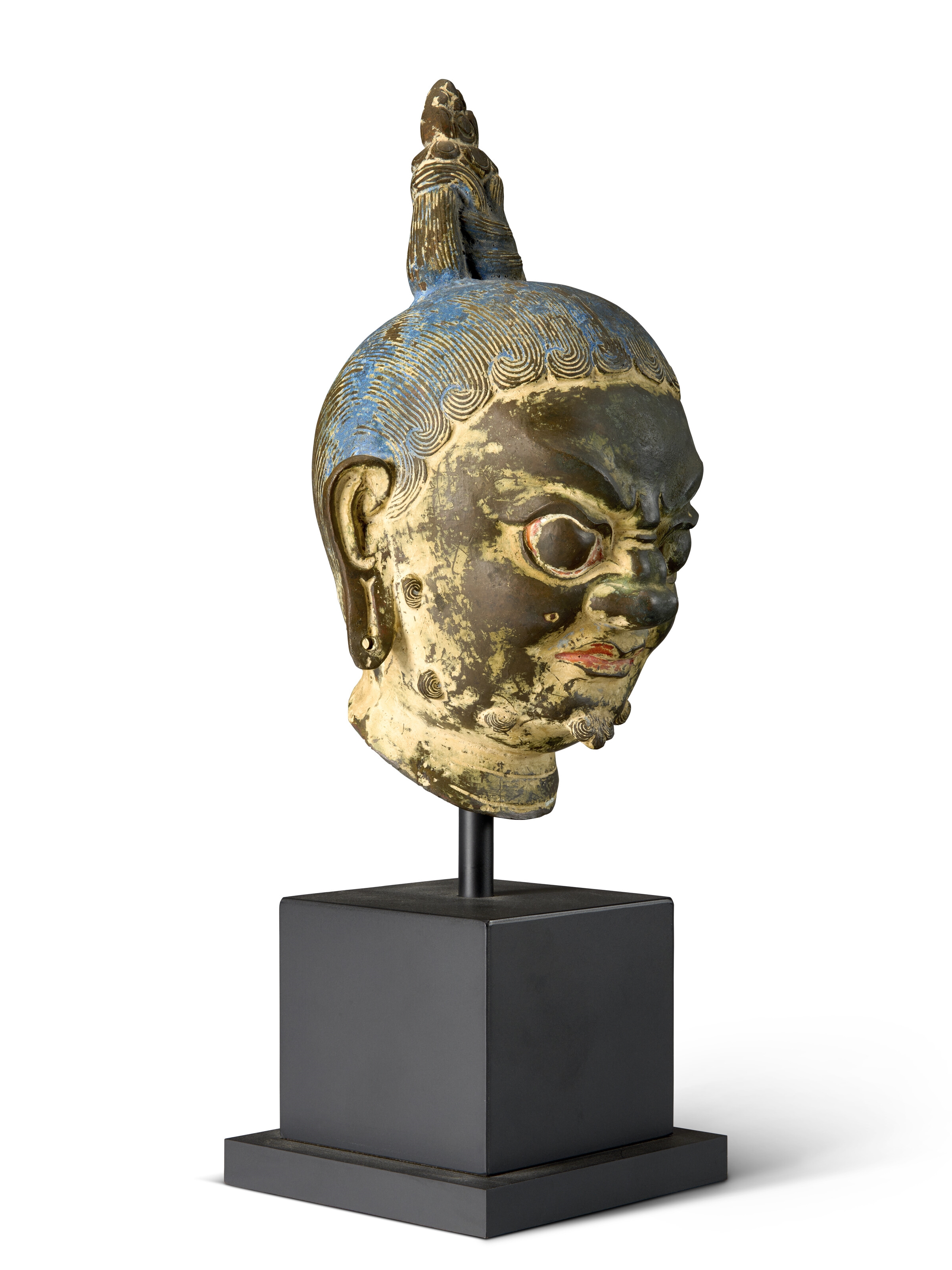 Tibetan School, 18th Century | A POLYCHROMED BRONZE HEAD OF A GUARDIAN ...