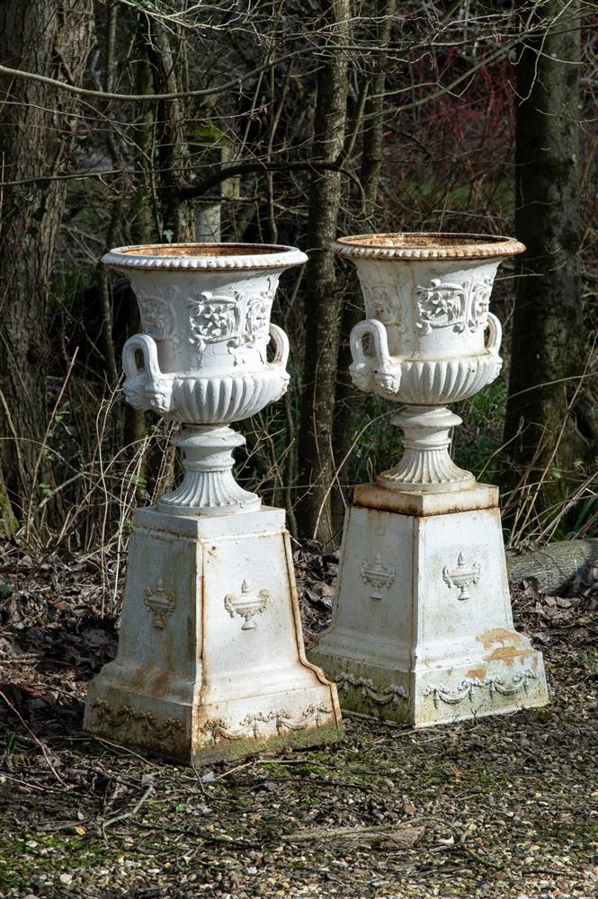 White | A LARGE PAIR OF WHITE PAINTED CAST IRON GARDEN URNS ON ...