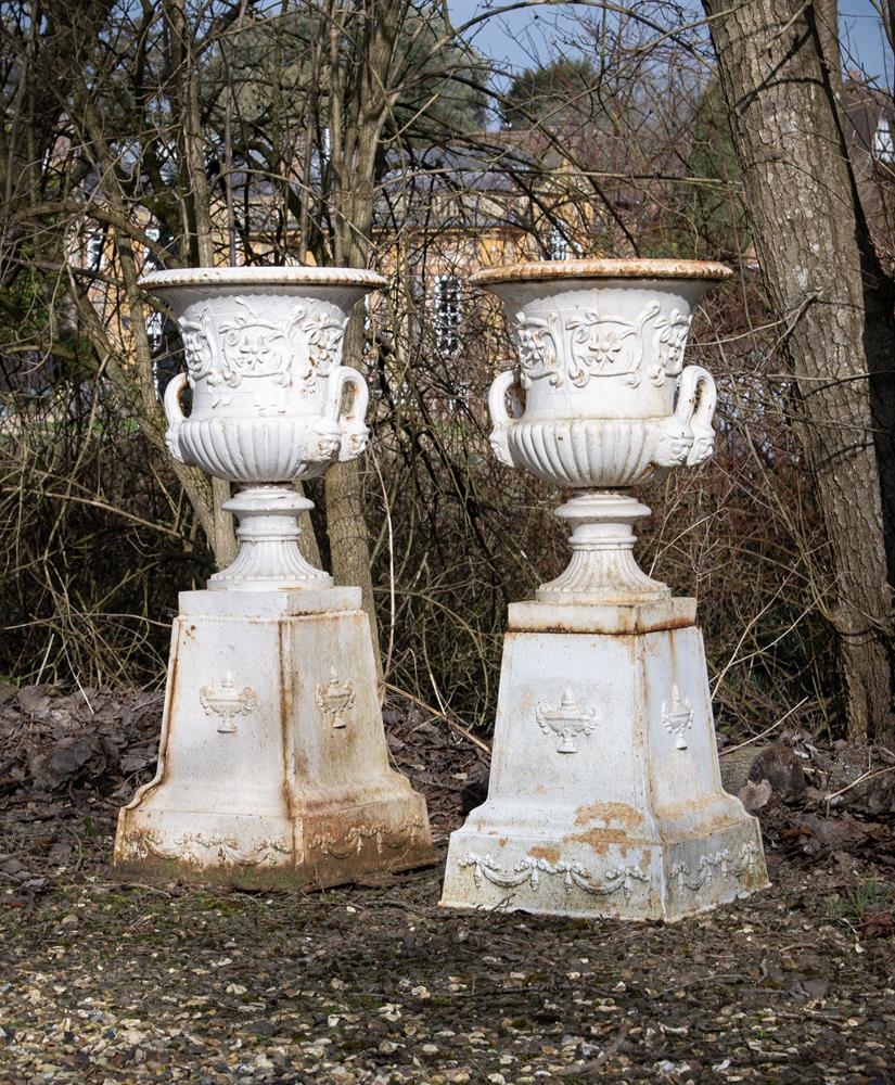White | A LARGE PAIR OF WHITE PAINTED CAST IRON GARDEN URNS ON ...