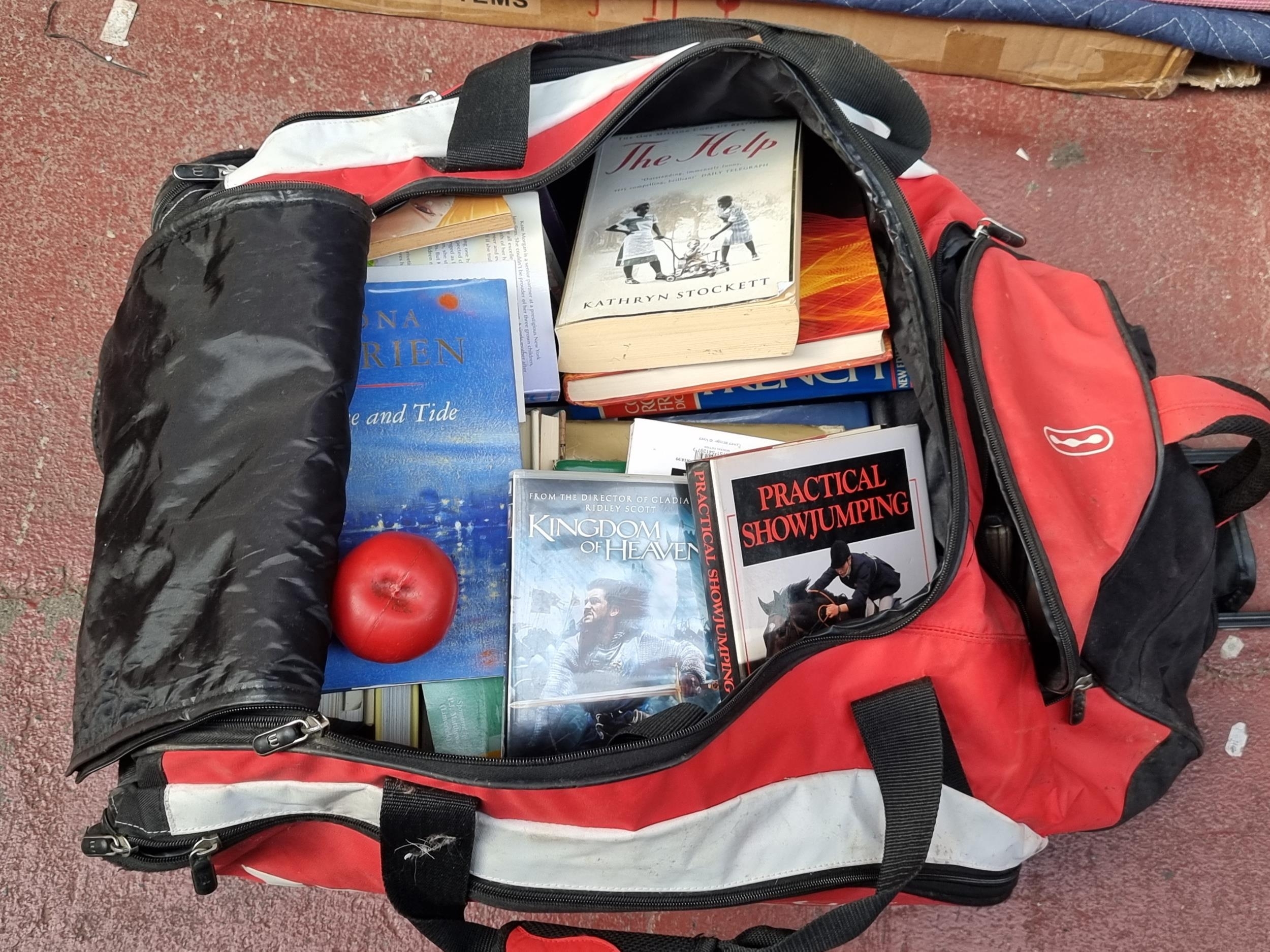 Wilson | A large Wilson branded tennis travel bag, full with an array ...