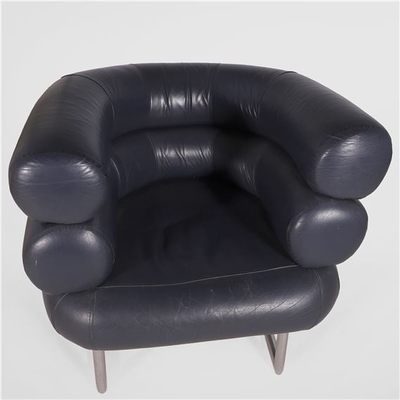 Eileen Gray | a Bibendum tub chair in dark blue leather on chrome ...