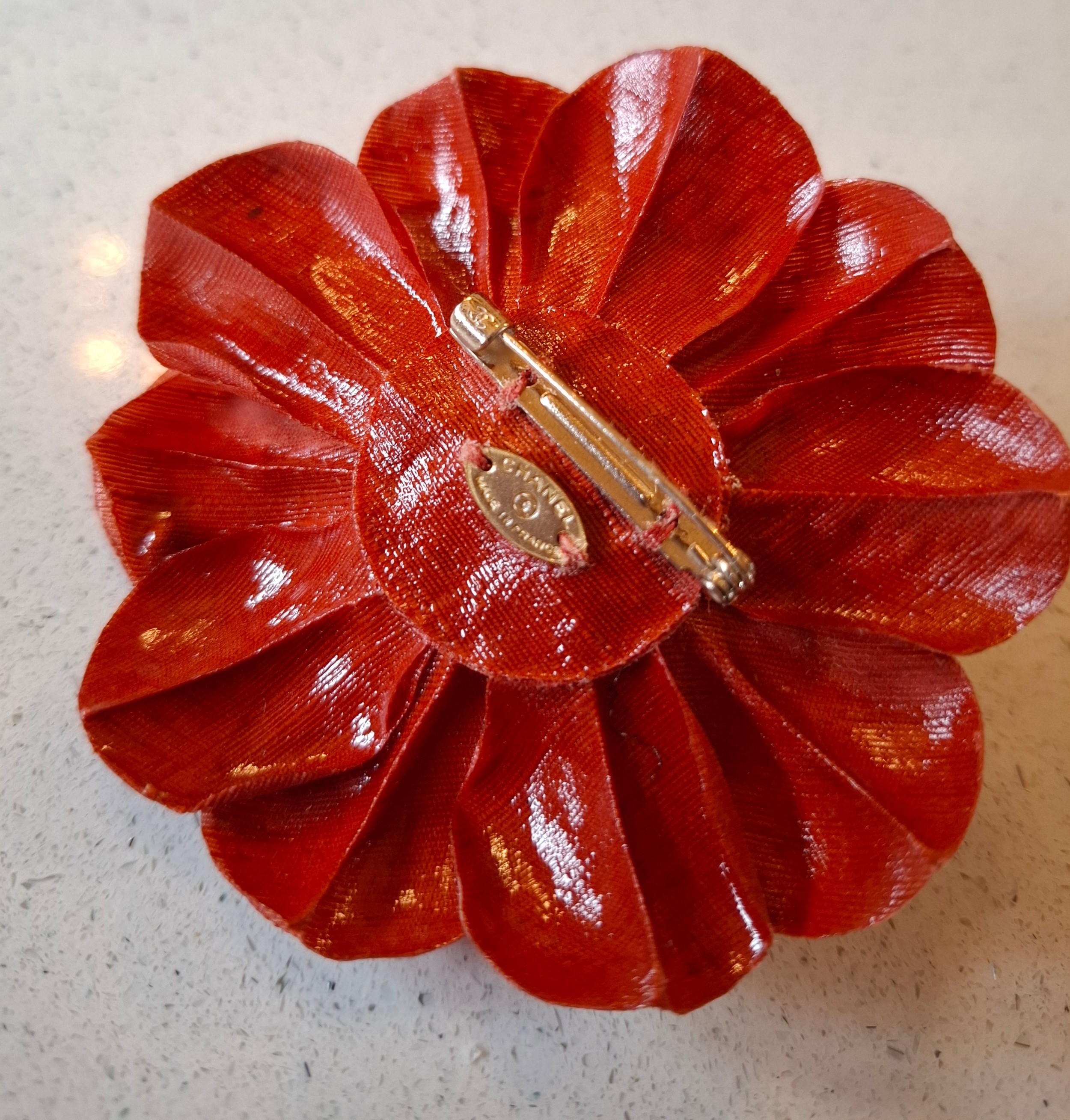 Chanel | Chanel-A large lacquered red Camelia brooch | MutualArt
