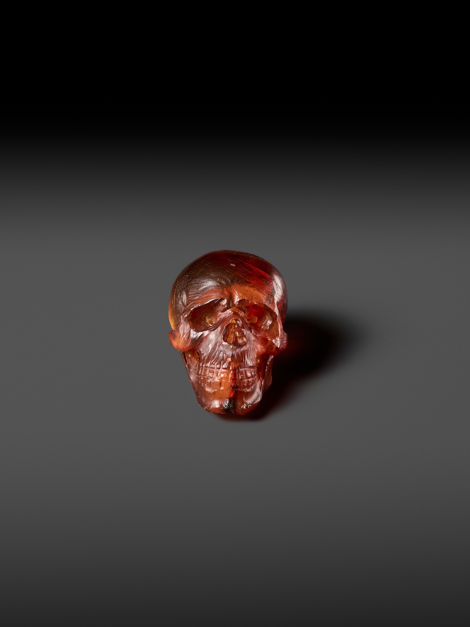 Japanese School, 19th Century | A RARE CARVED AMBER NETSUKE OF A SKULL ...
