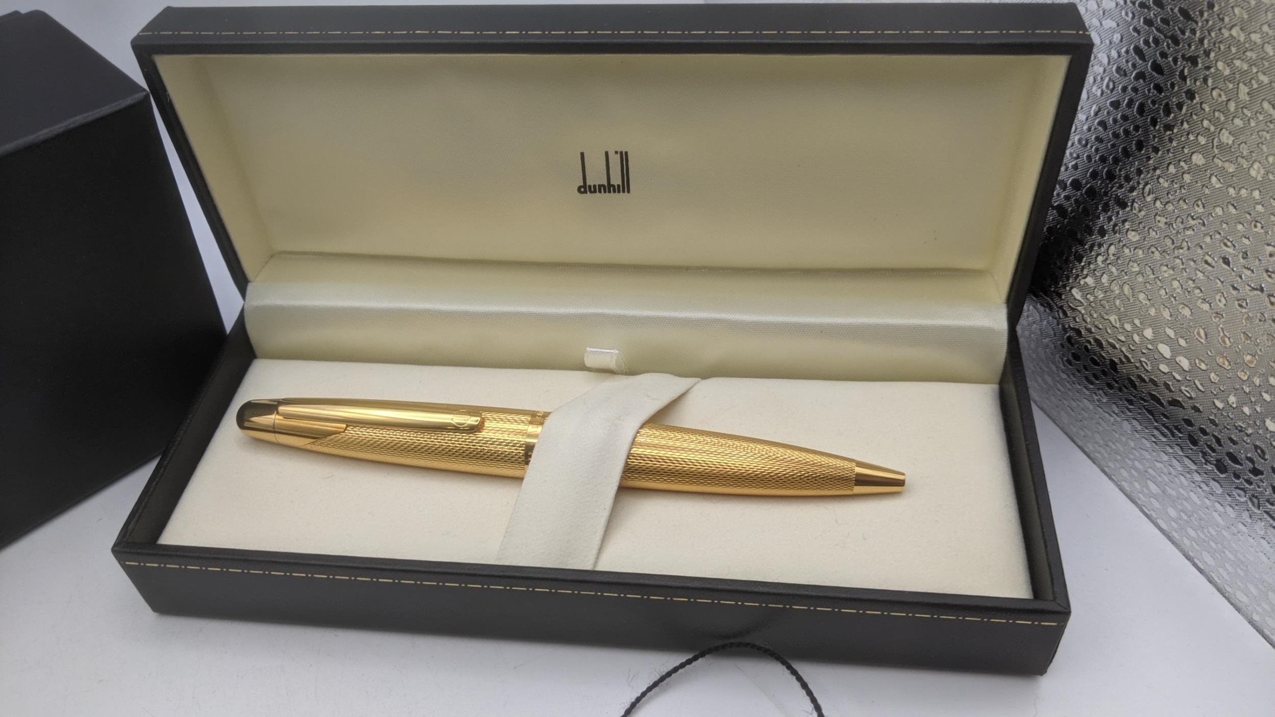 Alfred Dunhill | A gold plated Alfred Dunhill ballpoint pen with an ...