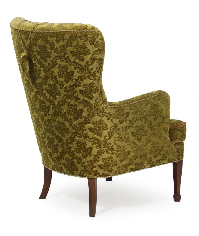 Frits Henningsen | A mahogany frame wingback chair upholstered with ...