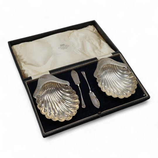 George Howson | A cased pair of George V silver butter shells, with ...