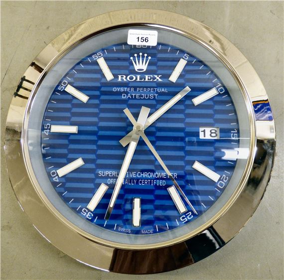 Rolex | A Rolex retailers shop display wall clock with a battery pow ...