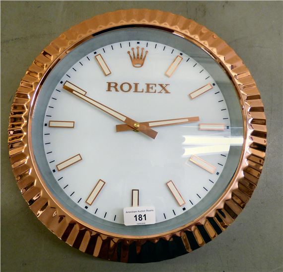 Rolex | A Rolex retailers shop display wall clock with a battery pow ...