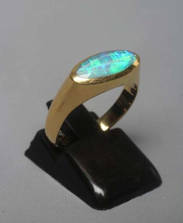Sheffield | A BLACK OPAL RING, the eliptical polished stone in a rub ...