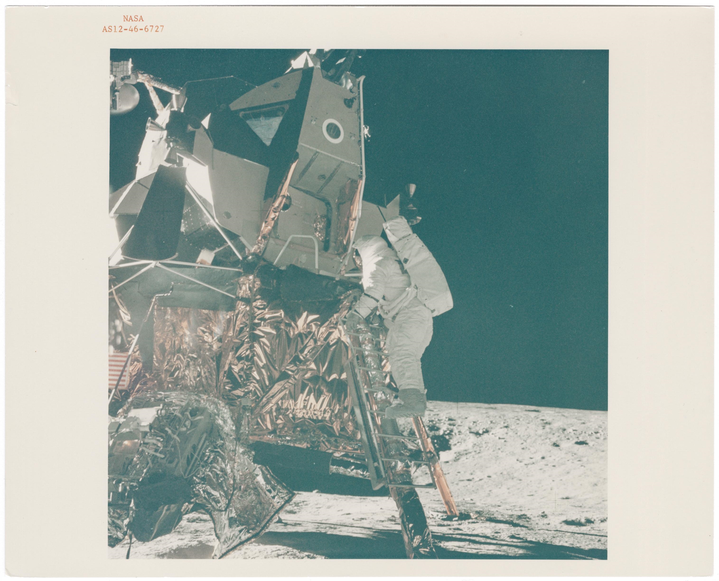 Charles Conrad | Alan Bean climbing down the LM Intrepid ladder to make ...