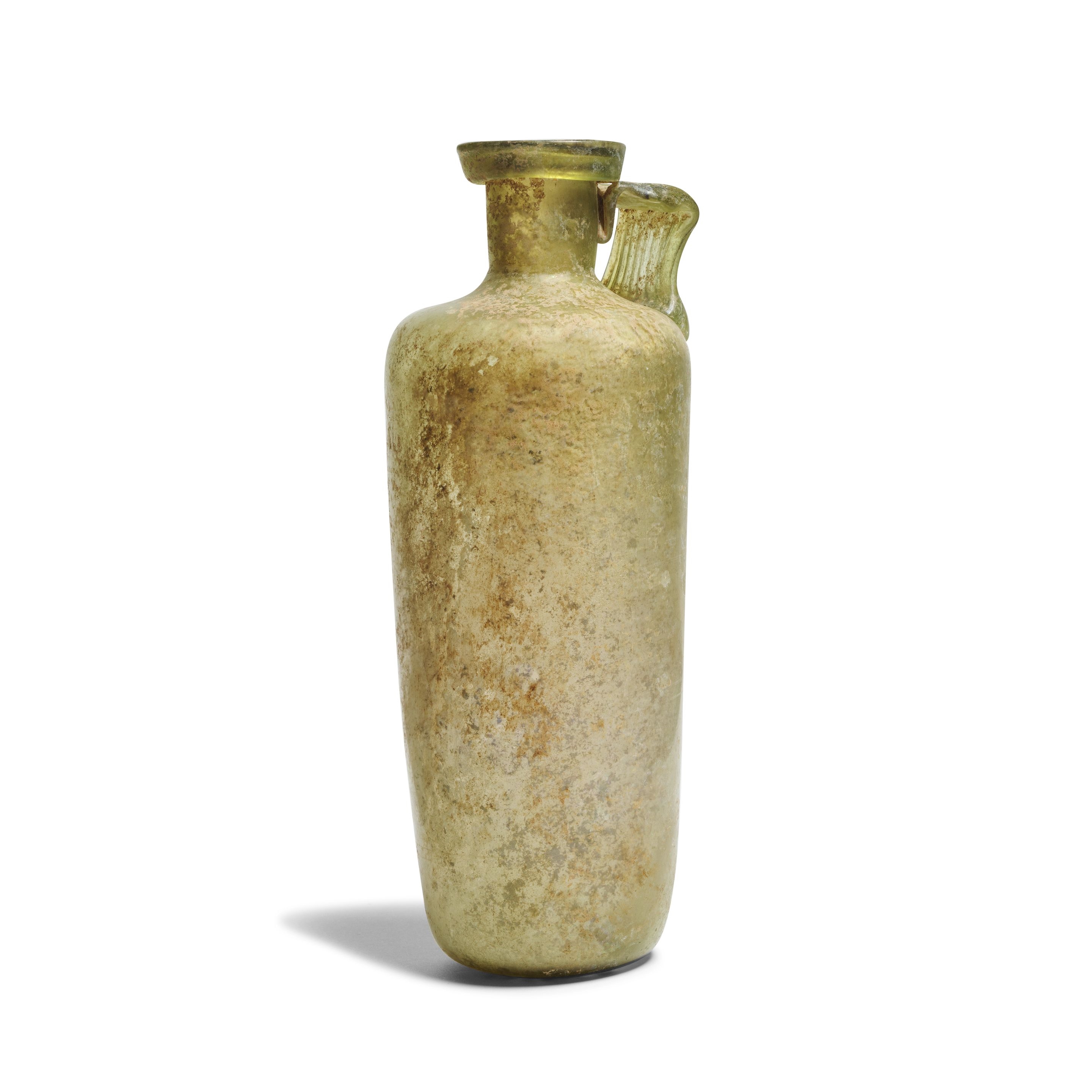 Roman School | A cylindrical Roman green glass vessel (1st Century 3rd ...