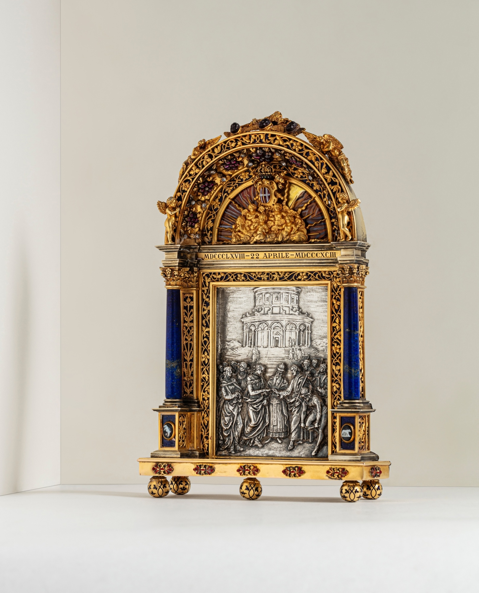 Raffaello Sanzio | An Italian gold, parcel-gilt, lapis-lazuli and rubies kiss of charity, signed ...