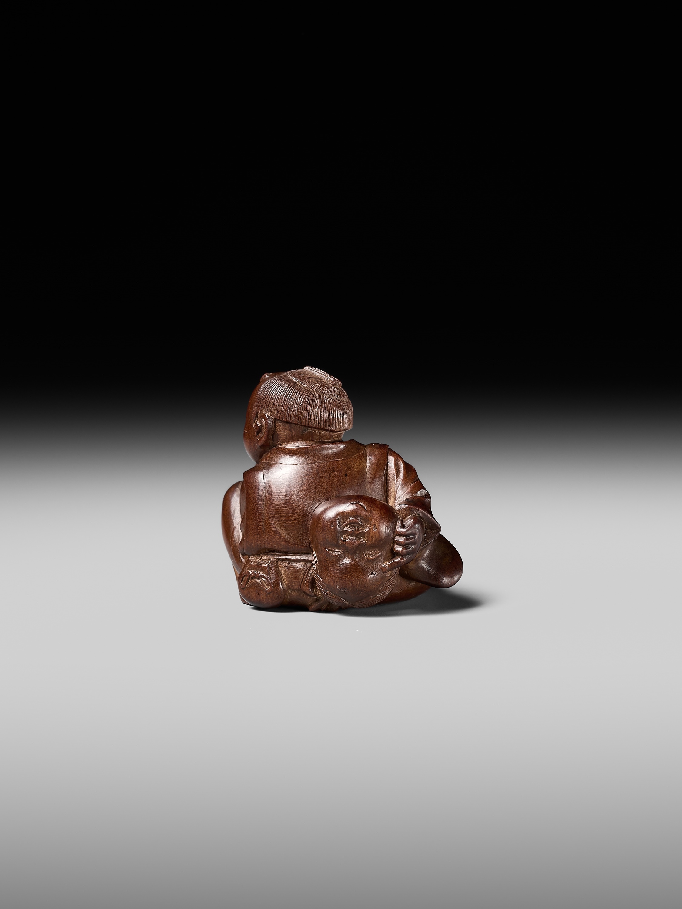 Miwa | AN INLAID WOOD NETSUKE OF A BOY WITH OKAME MASK (Early 19th ...